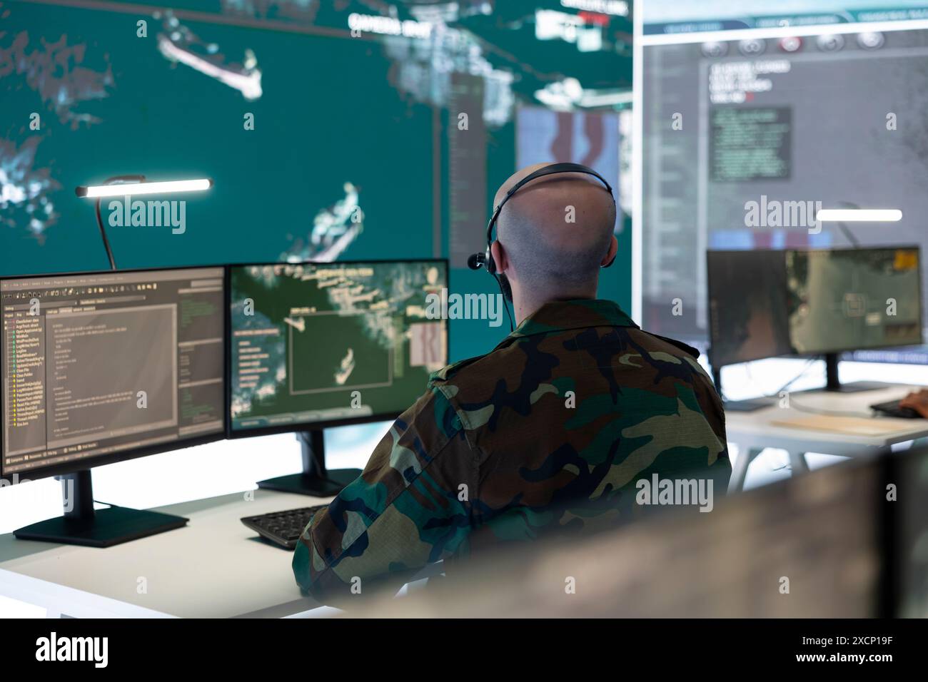 IT engineer operator examines surveillance footage from satellite ...