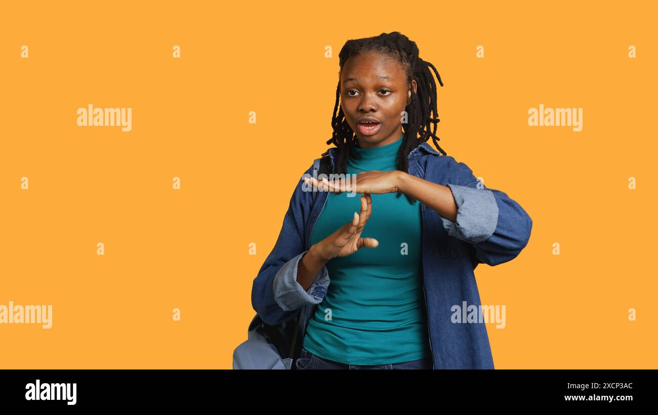 Portrait of assertive woman asking for timeout, doing hand gestures ...
