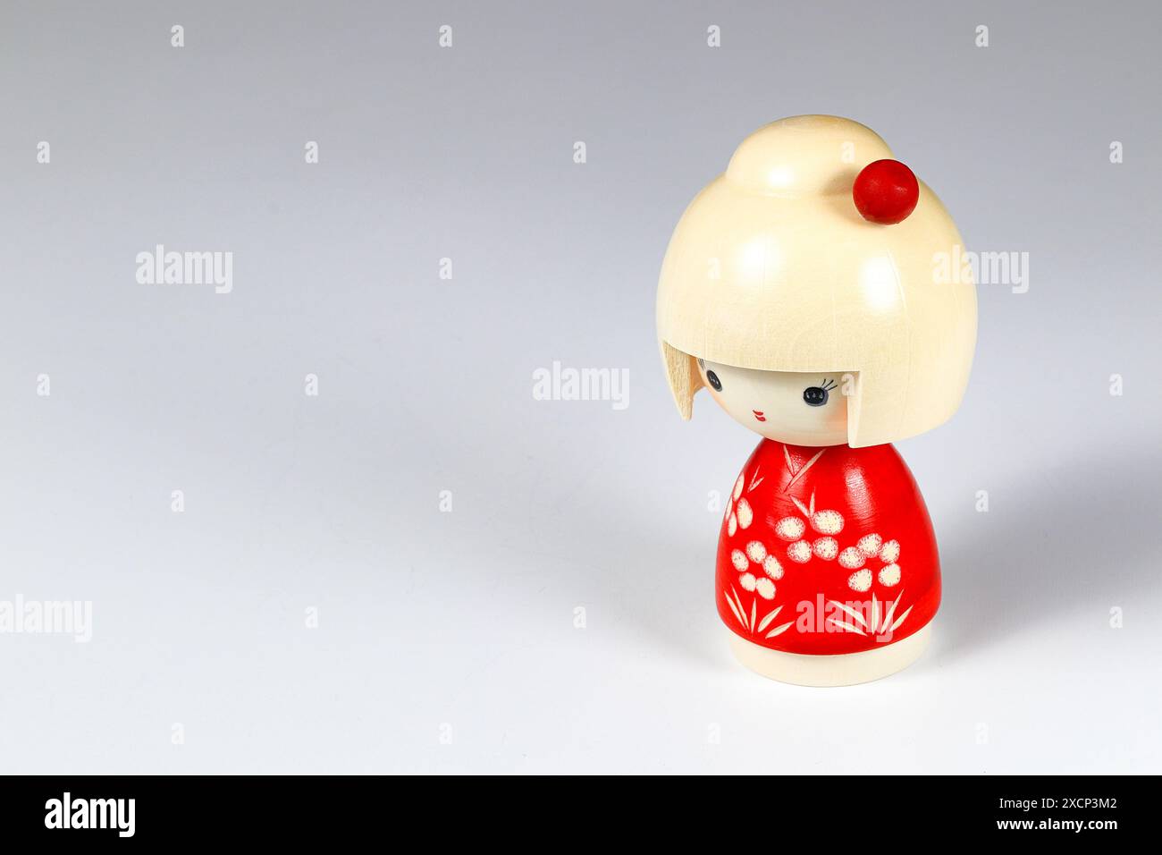 Japanese wooden dolls "kokeshi" in red Kimono suit, toy for a decoration, souvenir from Japan ...