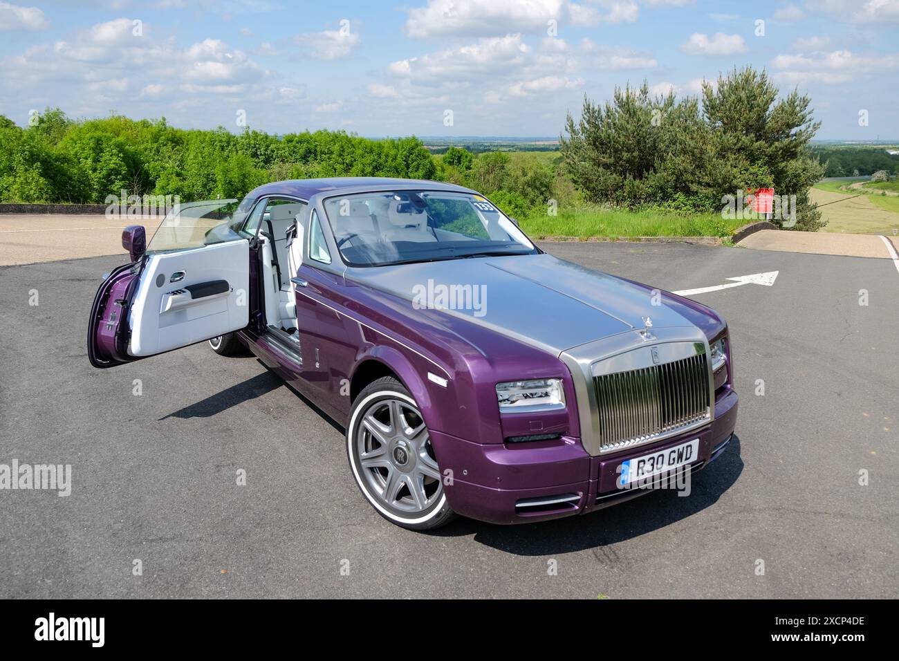 Rolls-Royce coupe with driver's door open, parked on a test track on a ...