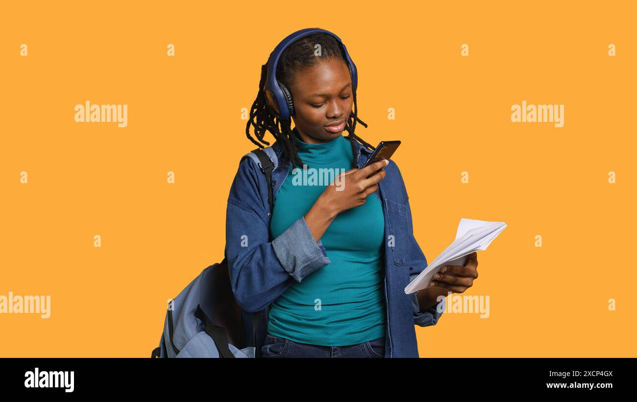 African american woman taking picture of school homework to send to ...