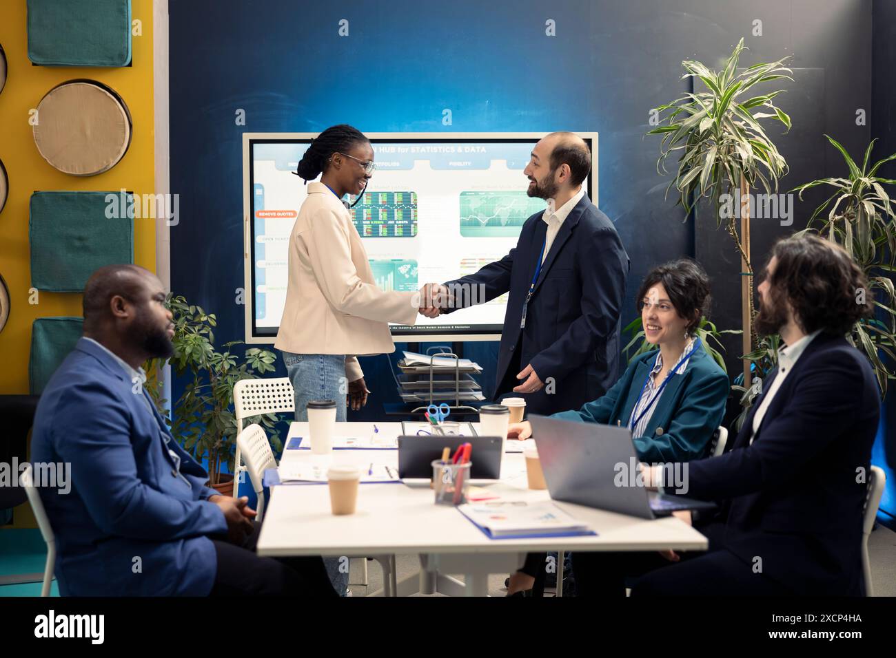 Company principal does handshake with a new woman employee during an ...