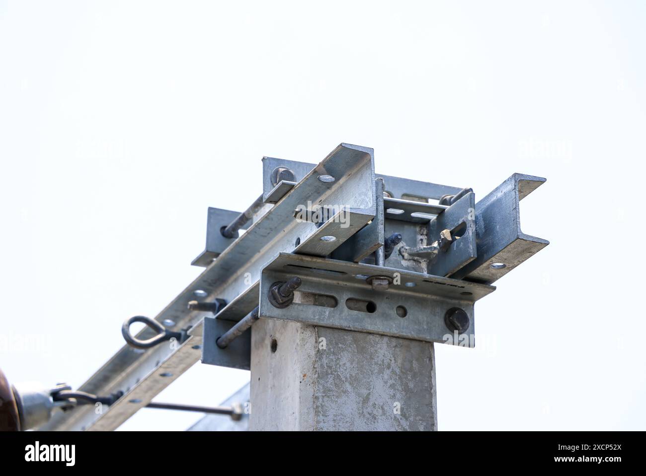 Steel bolt and nut on metal plates of concrete post, metal structure ...