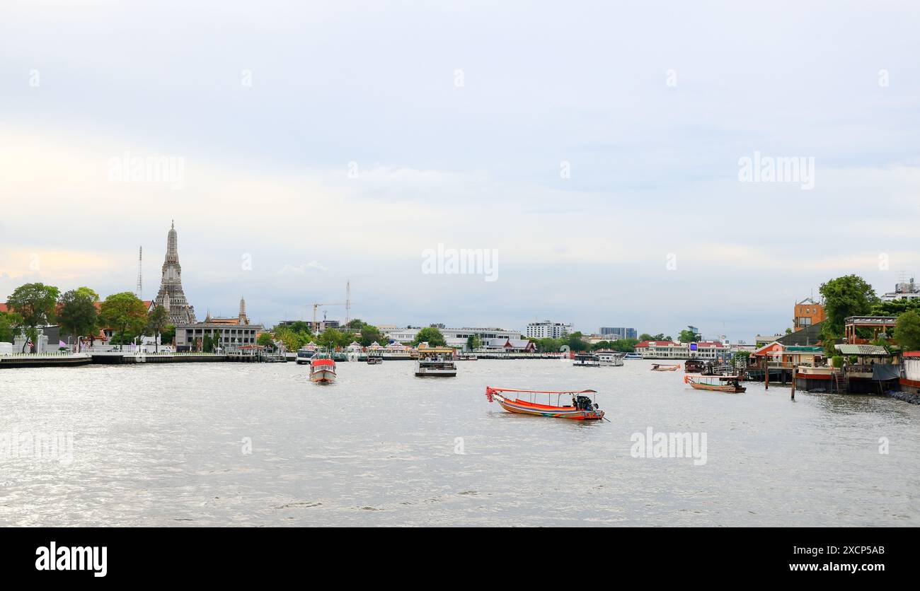 river traffic of boats and cargo barges on the Chao Phraya River at ...