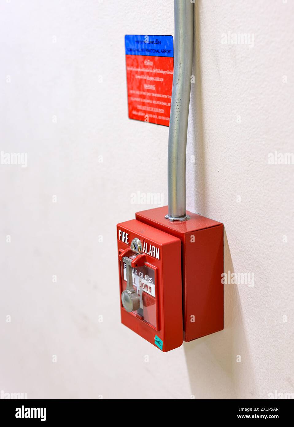 Fire alarm switch, button to activate Fire alarm on white concrete wall ...