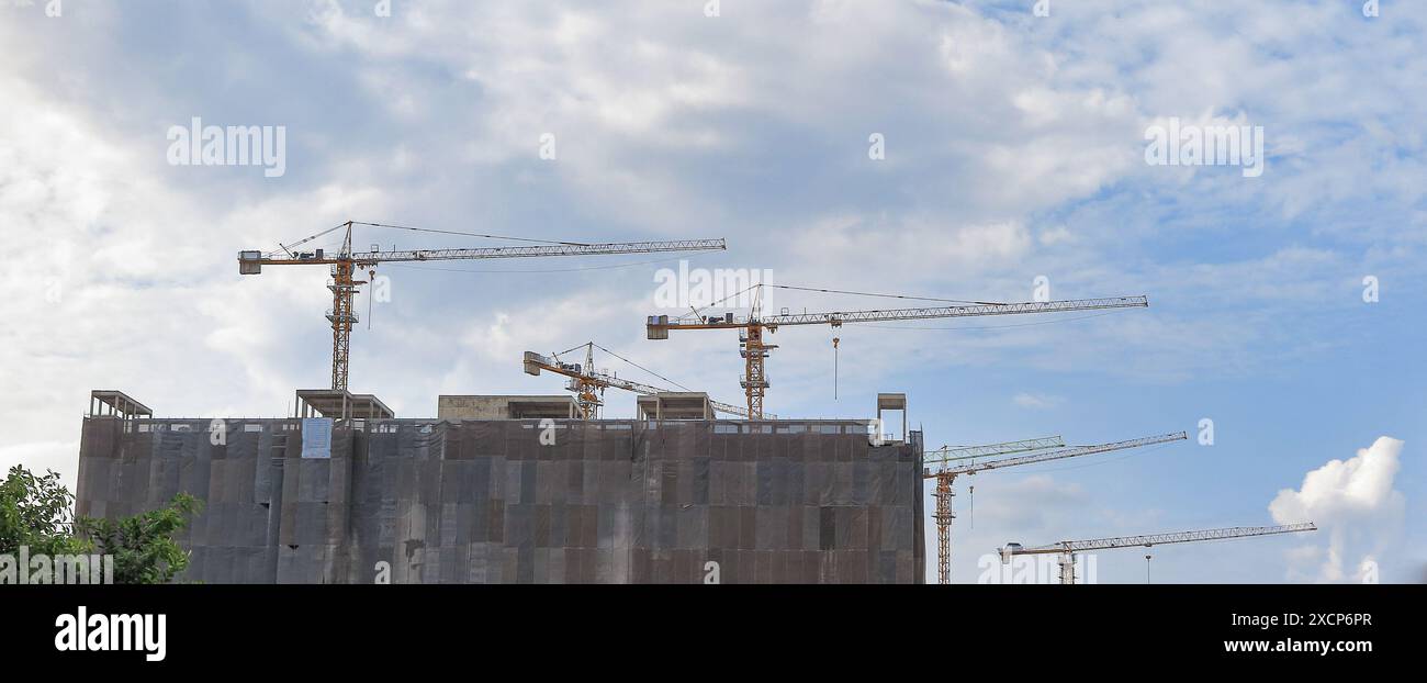 construction tower crane work with construction worker on top of ...
