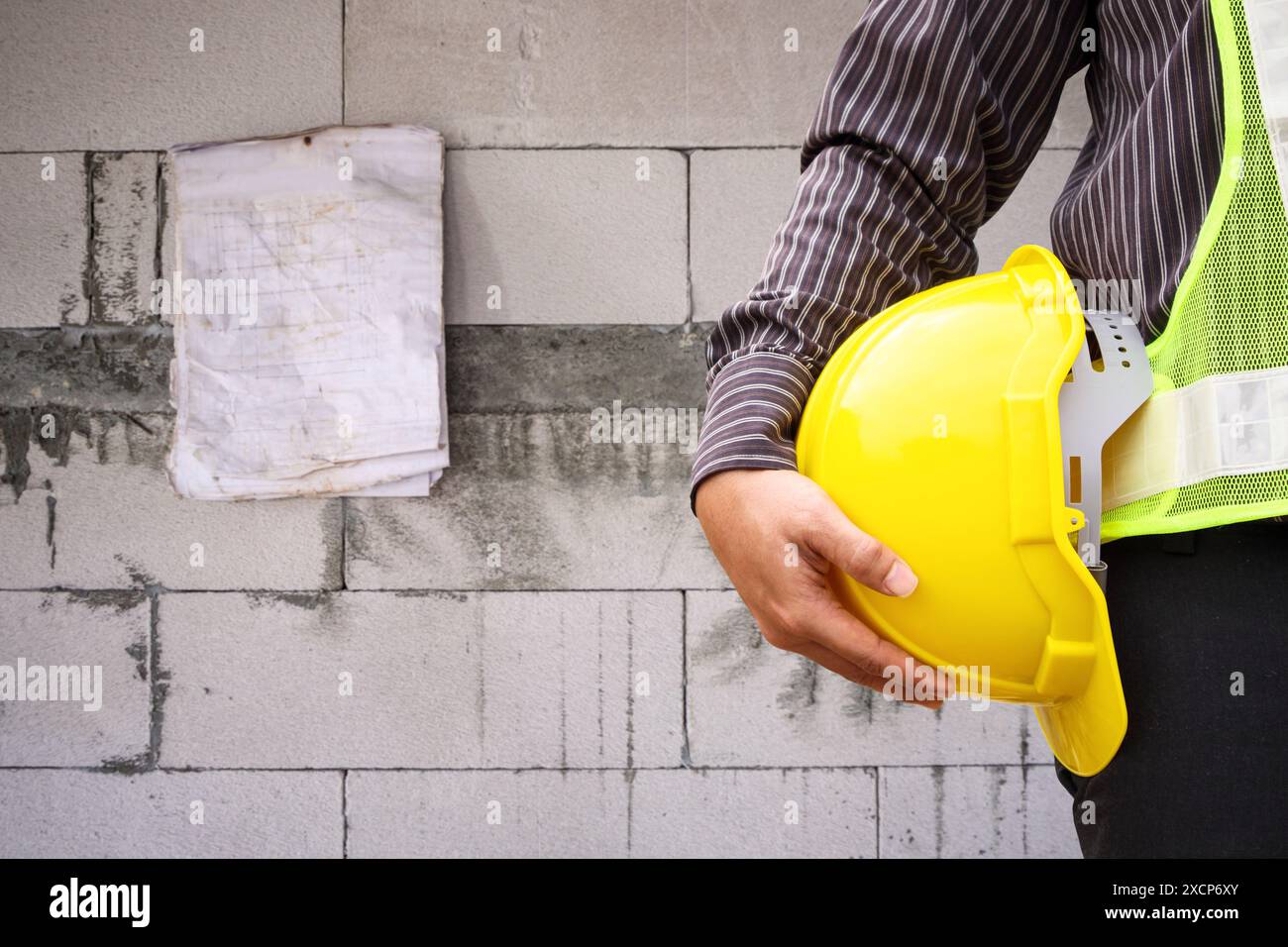 construction worker engineer at construction site wall with blue prints ...
