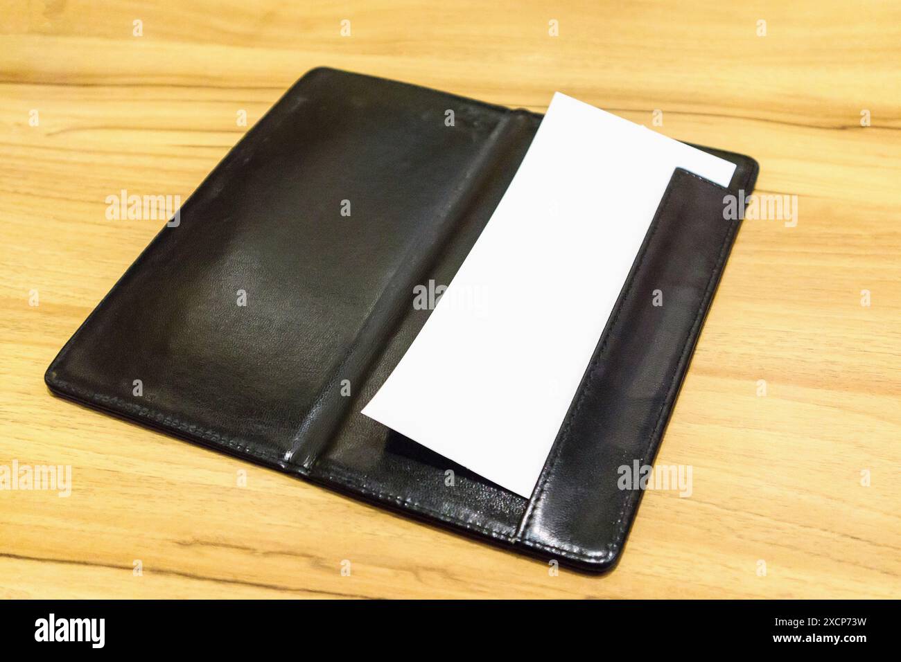 Blank empty white paper in restaurant payment billing receipt folder on ...