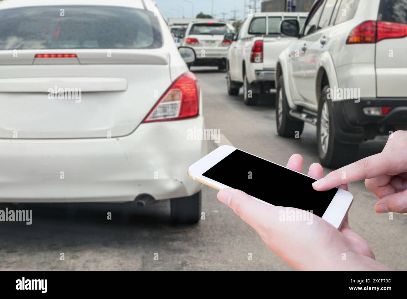 woman hand using mobile smart phone after car crash accident damage at ...