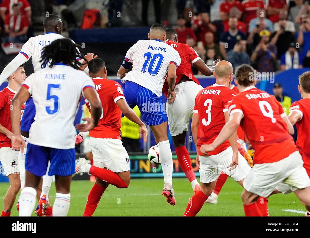 France's Kylian Mbappe hits his head on the shoulder of Austria's Kevin ...