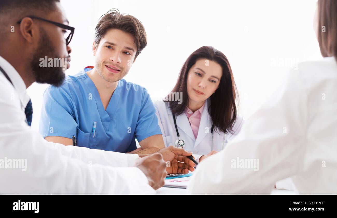 Doctors interacting at meeting in conference room Stock Photo - Alamy