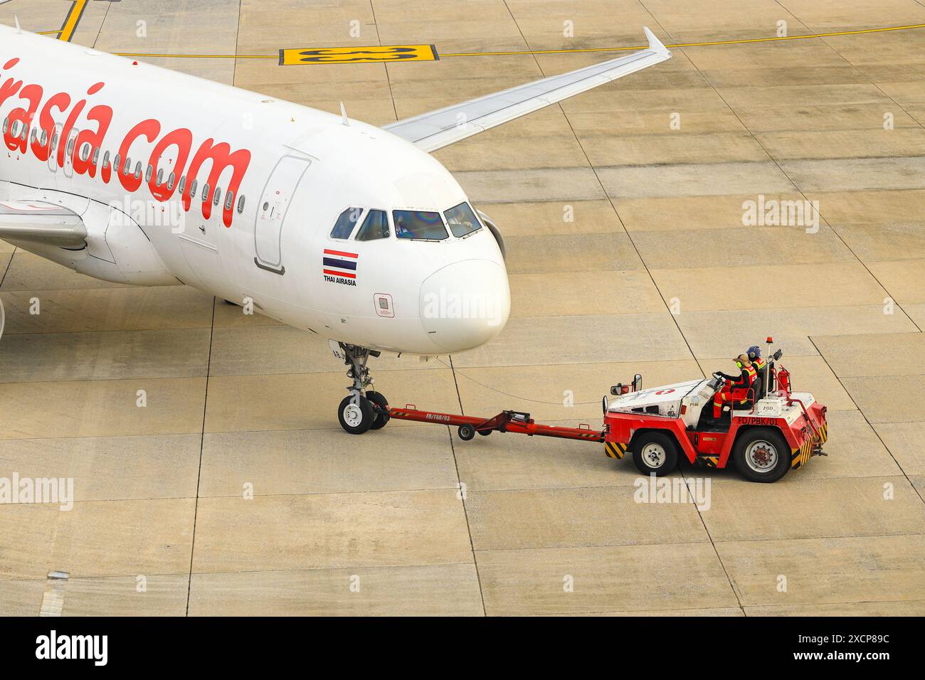 Aircraft are pushed back to the taxiway by airplane tugs, with one in ...