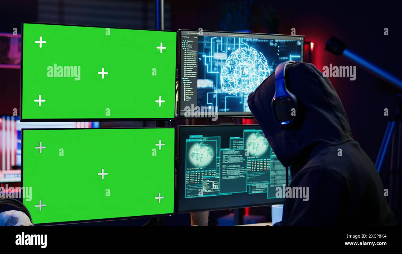 Hacker using isolated screen monitor and artificial intelligence to write spyware software ...