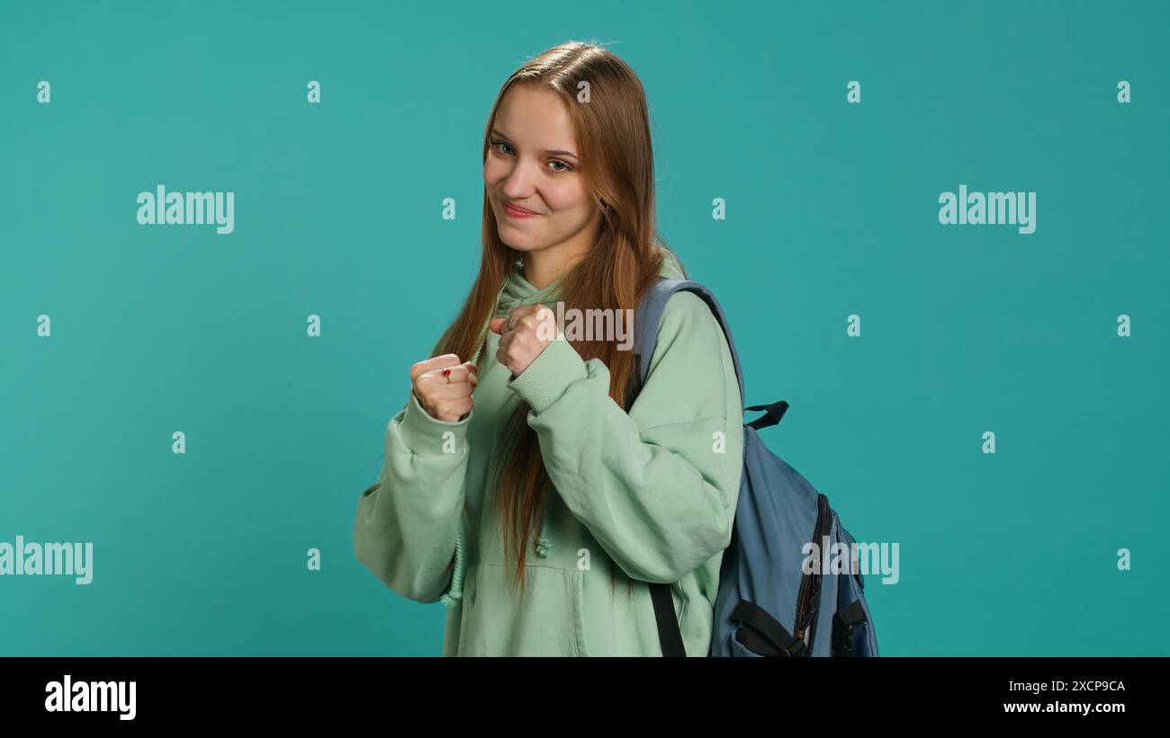 Woman doing fighting stance, pretending to do boxing, isolated over ...