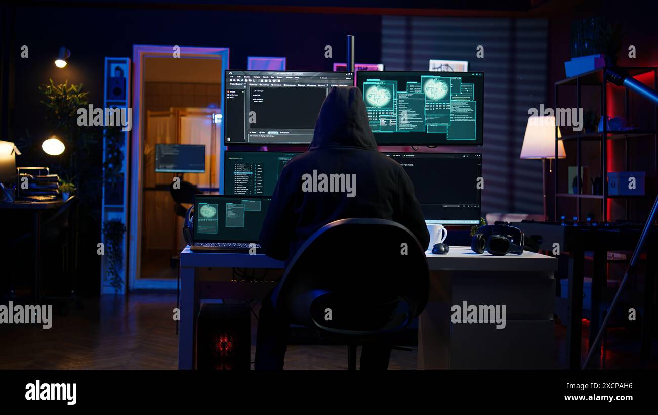 Hacker arriving in secret base with laptop, ready to start programming viruses. Scammer in ...