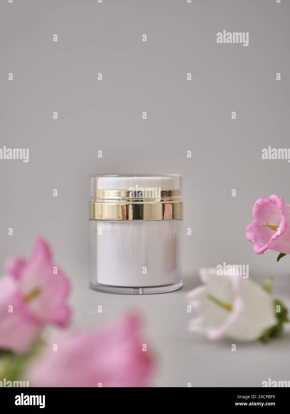 Skin care products on neutral background. Mockup bottles and flowers ...