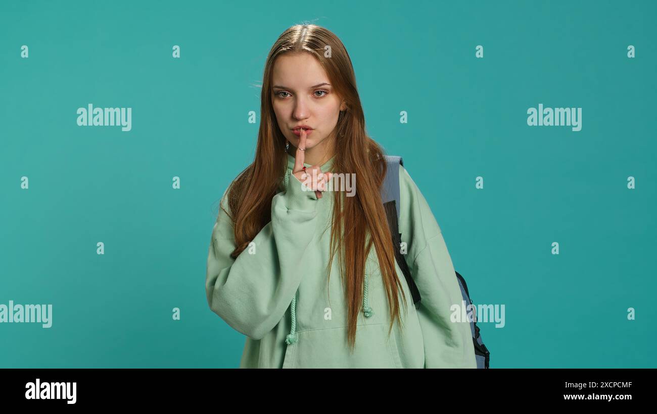 Stern woman doing shushing hand gesturing, irritated by noise, having ...