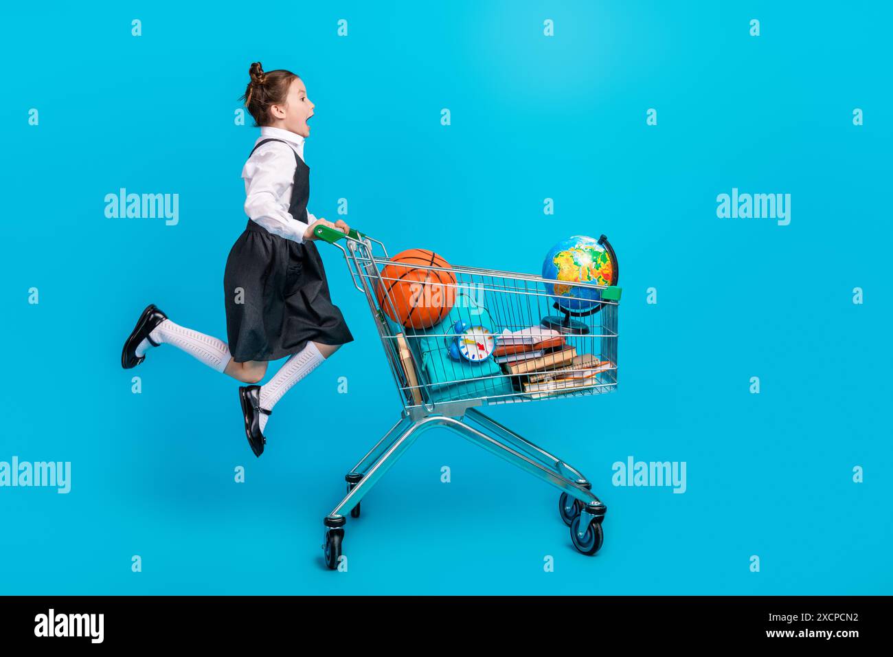 Full body photo of cute little girl push jump shopping cart black ...