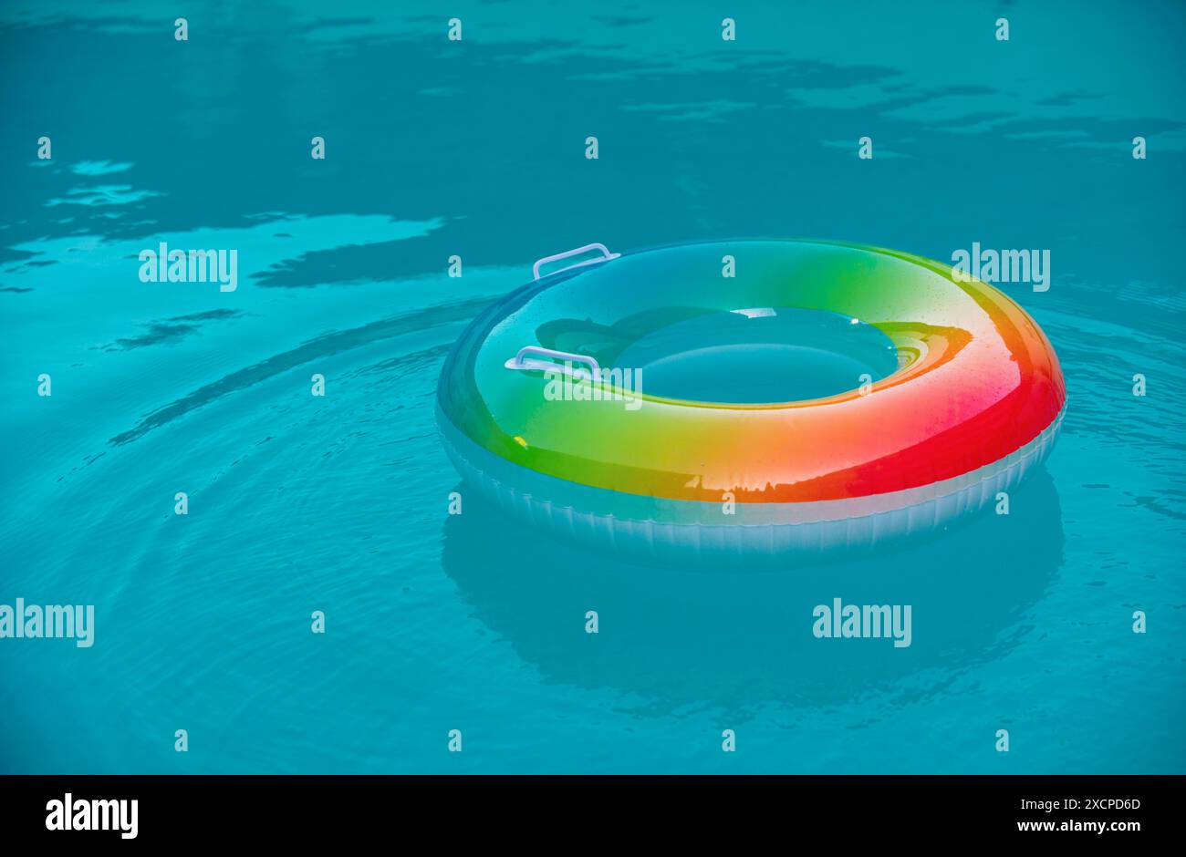 Floating ring on blue water swimpool background with waves reflecting ...