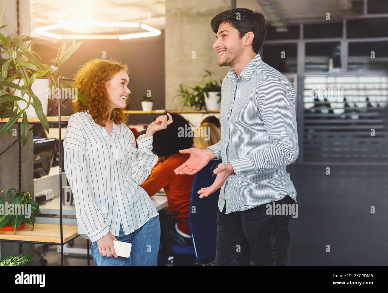 Chatting diverse coworkers standing hi-res stock photography and images ...