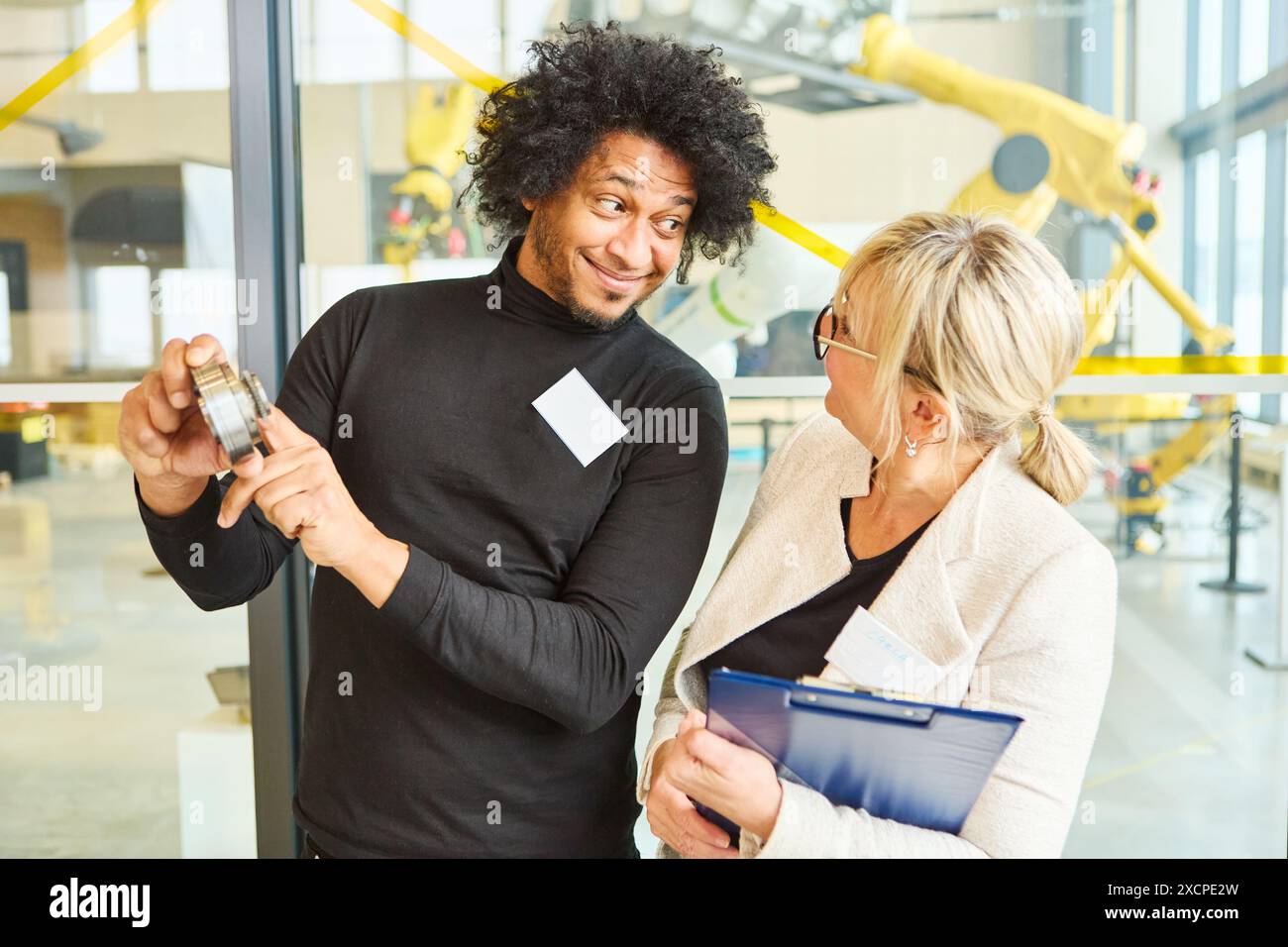 Two engineers engaging in a lively discussion about robotic automation ...