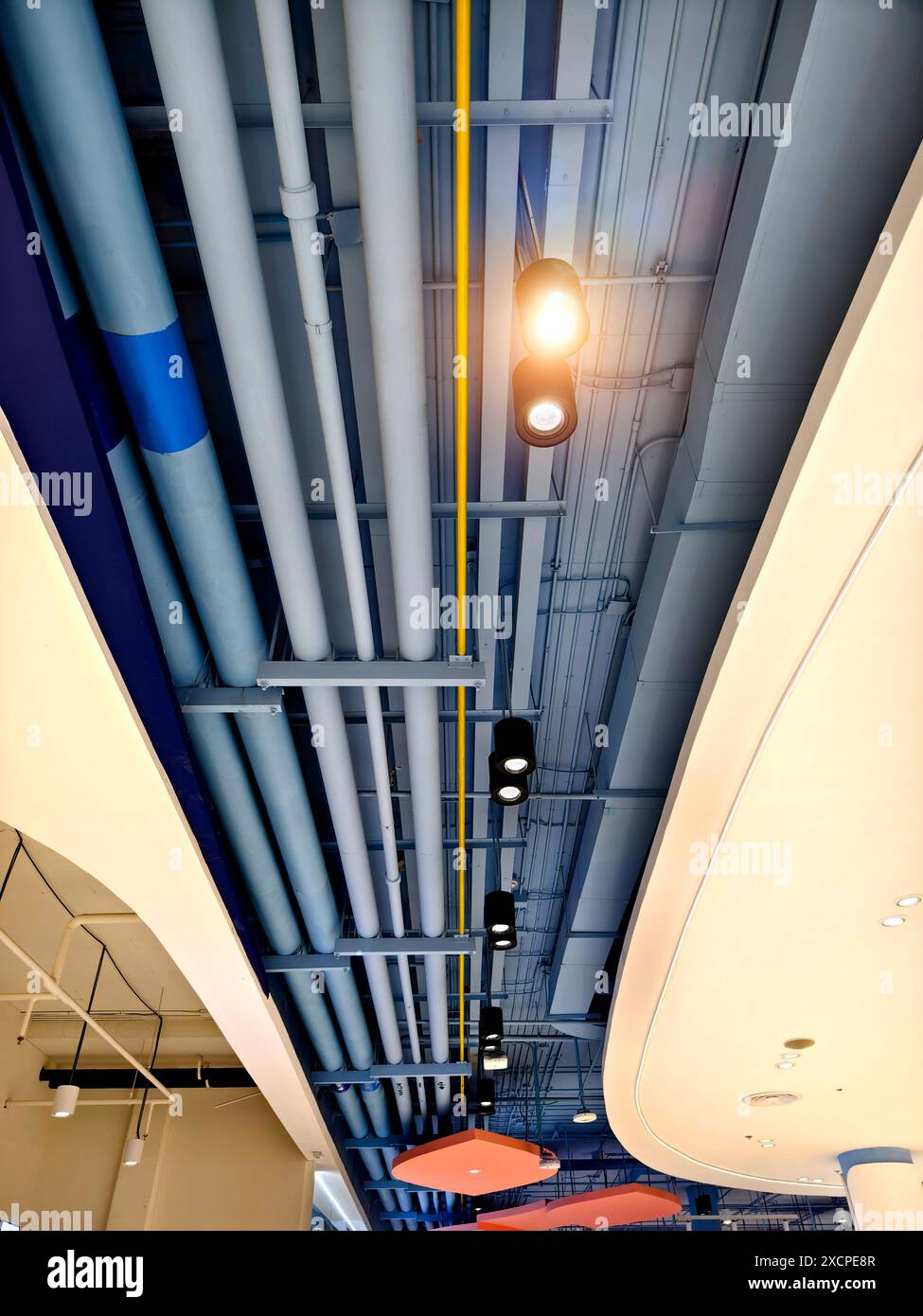 Ceiling with pipes and lights in creates industrial a pattern Stock ...
