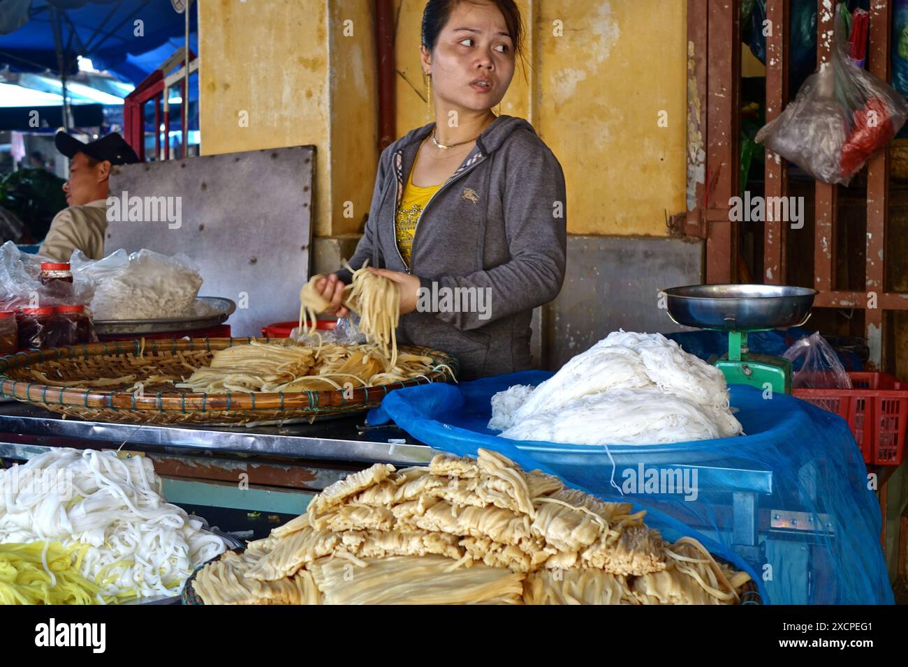 Vietnam. Vietnamese girl selling fresh noodles at covered market in Hoi ...