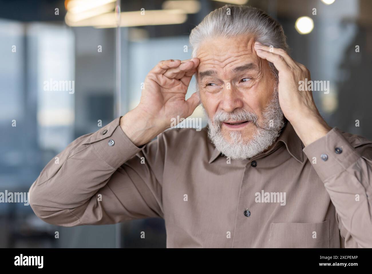 Elderly man experiencing head pain and headache. Mature man in stress ...