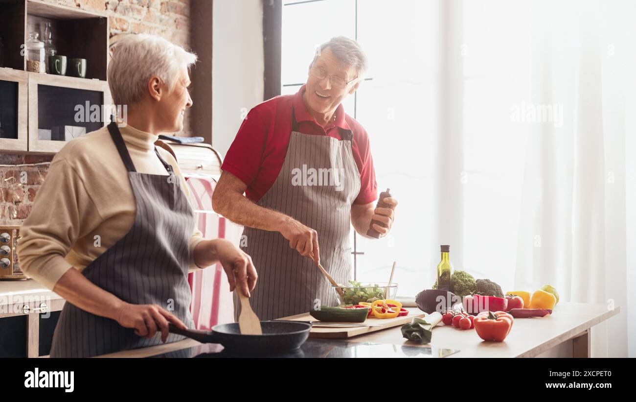 Senior Couple Cooking Together in a Modern Kitchen, Sun Flare Stock ...