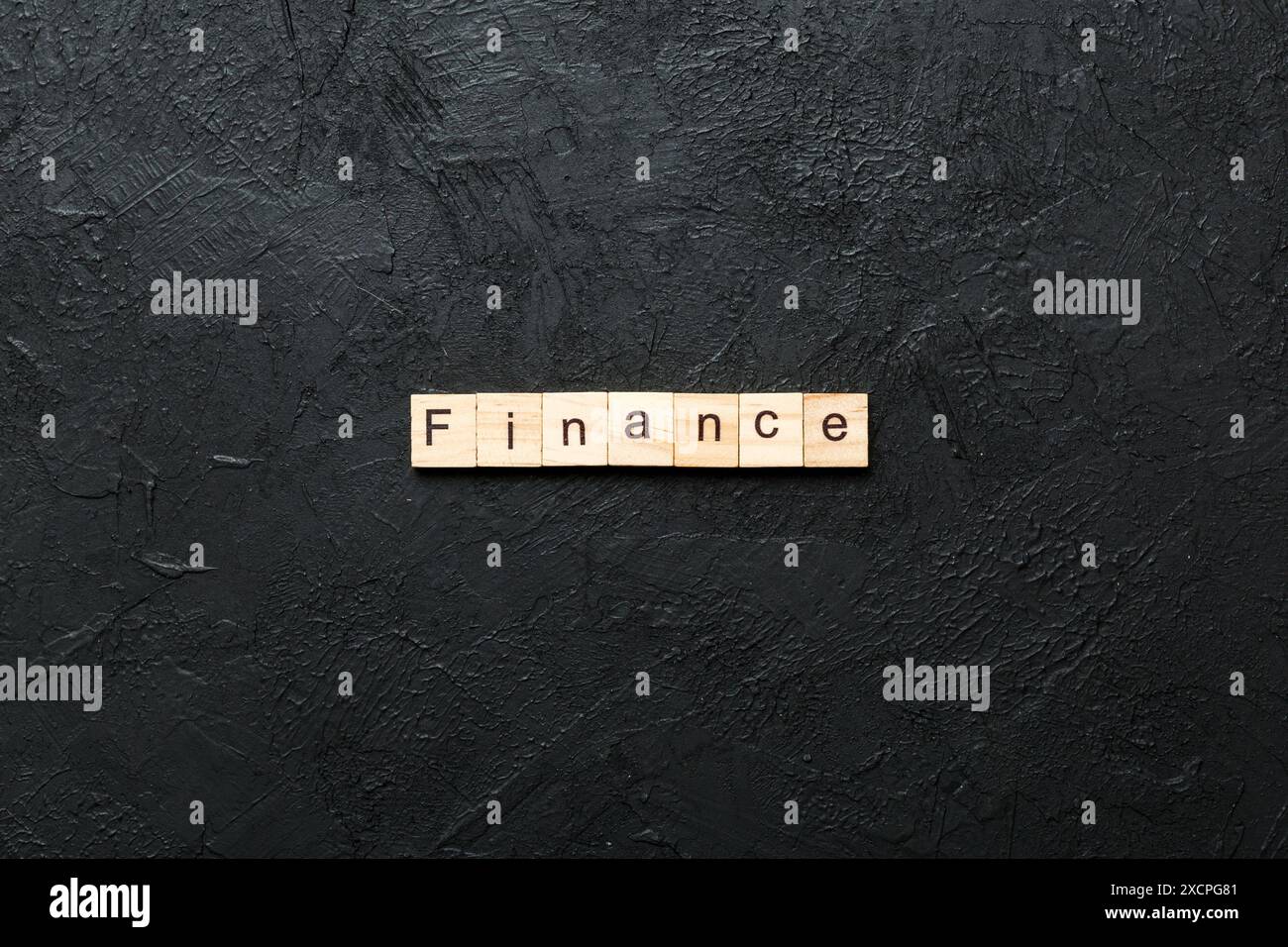 FINANCE word written on wood block. FINANCE text on cement table for ...