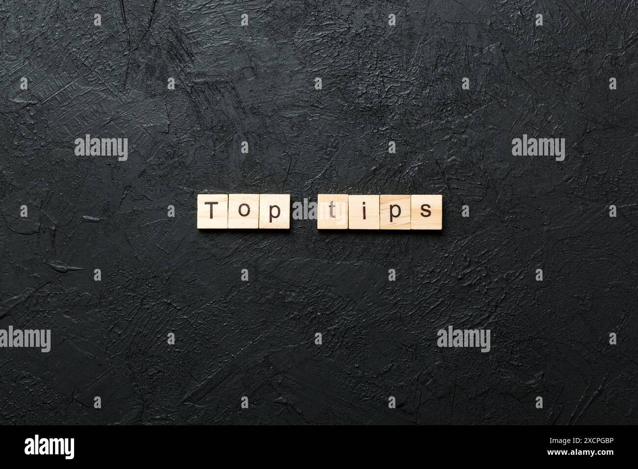 Top tips word written on wood block. Top tips text on cement table for ...
