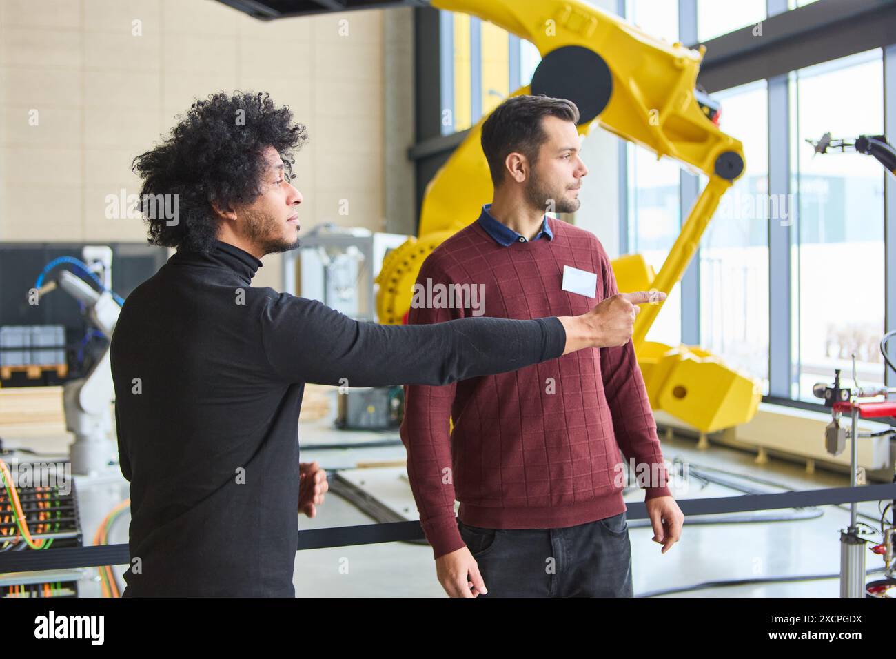 Engineers discussing robotics technology and programming in an ...