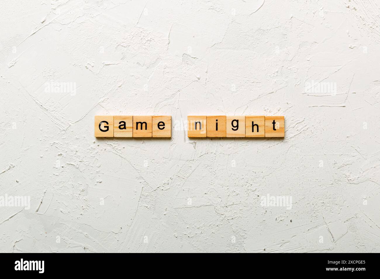 Game Night word written on wood block. Game Night text on cement table ...