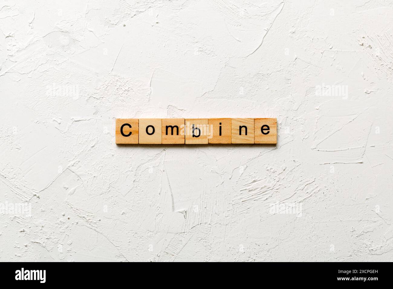 COMBINE word written on wood block. COMBINE text on cement table for ...