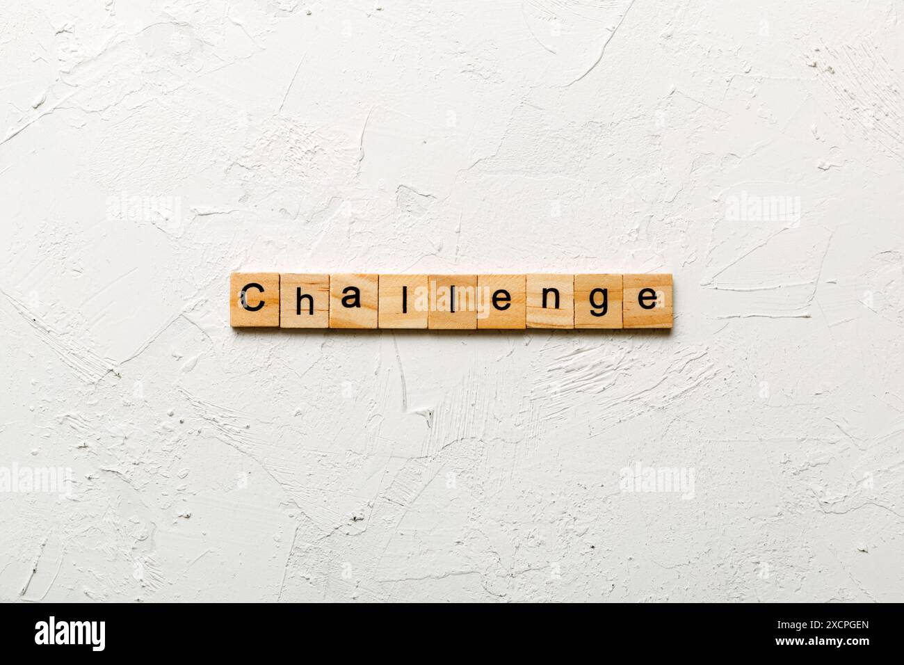 CHALLENGE word written on wood block. CHALLENGE text on cement table ...
