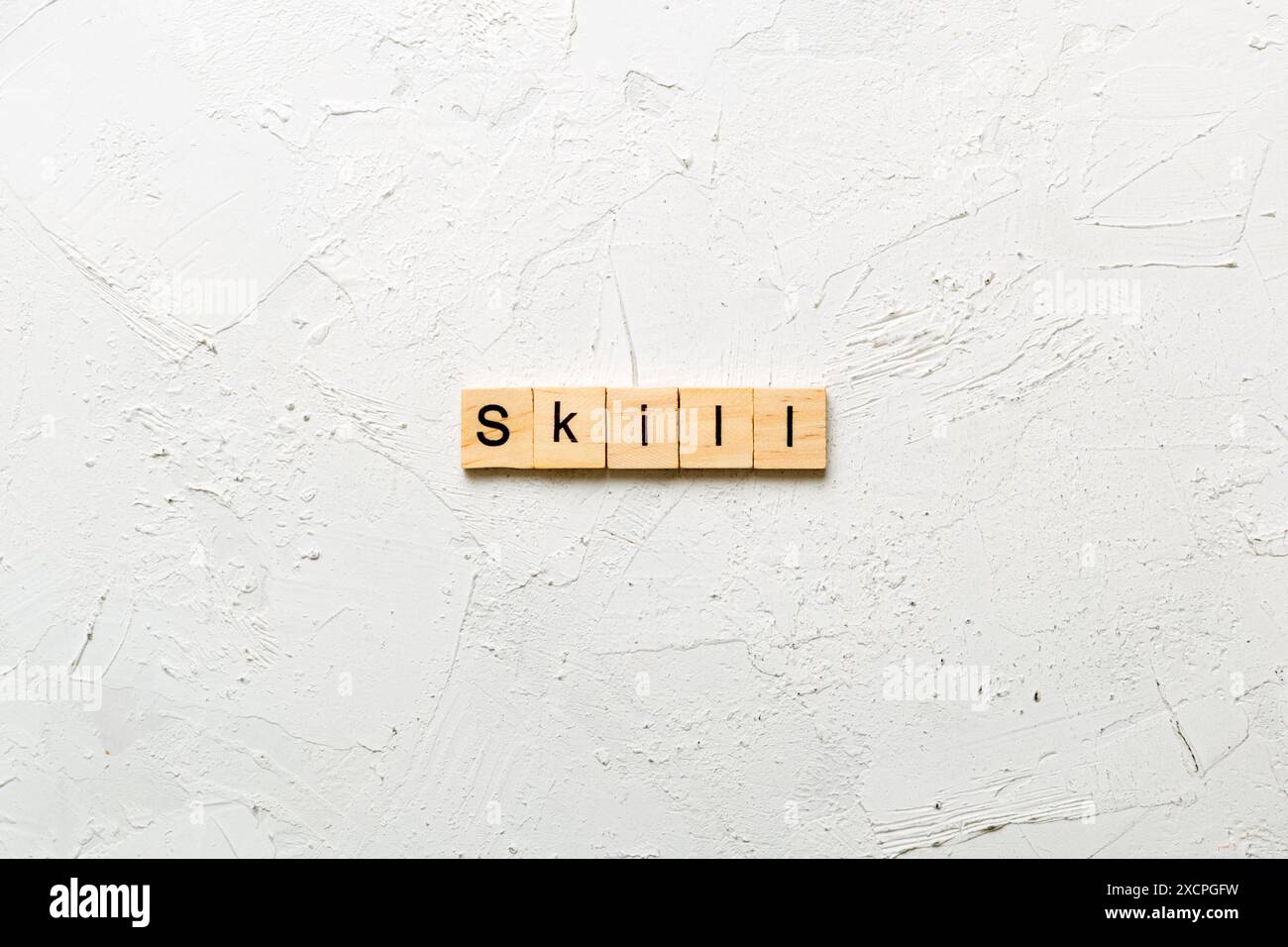 Skill word written on wood block. Skill text on cement table for your ...
