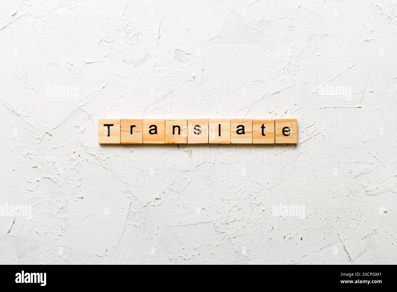 Translate word written on wood block. Translate text on cement table ...