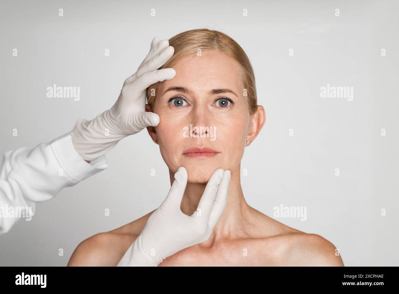 Woman Receiving Facial Examination by Gloved Hands Stock Photo - Alamy