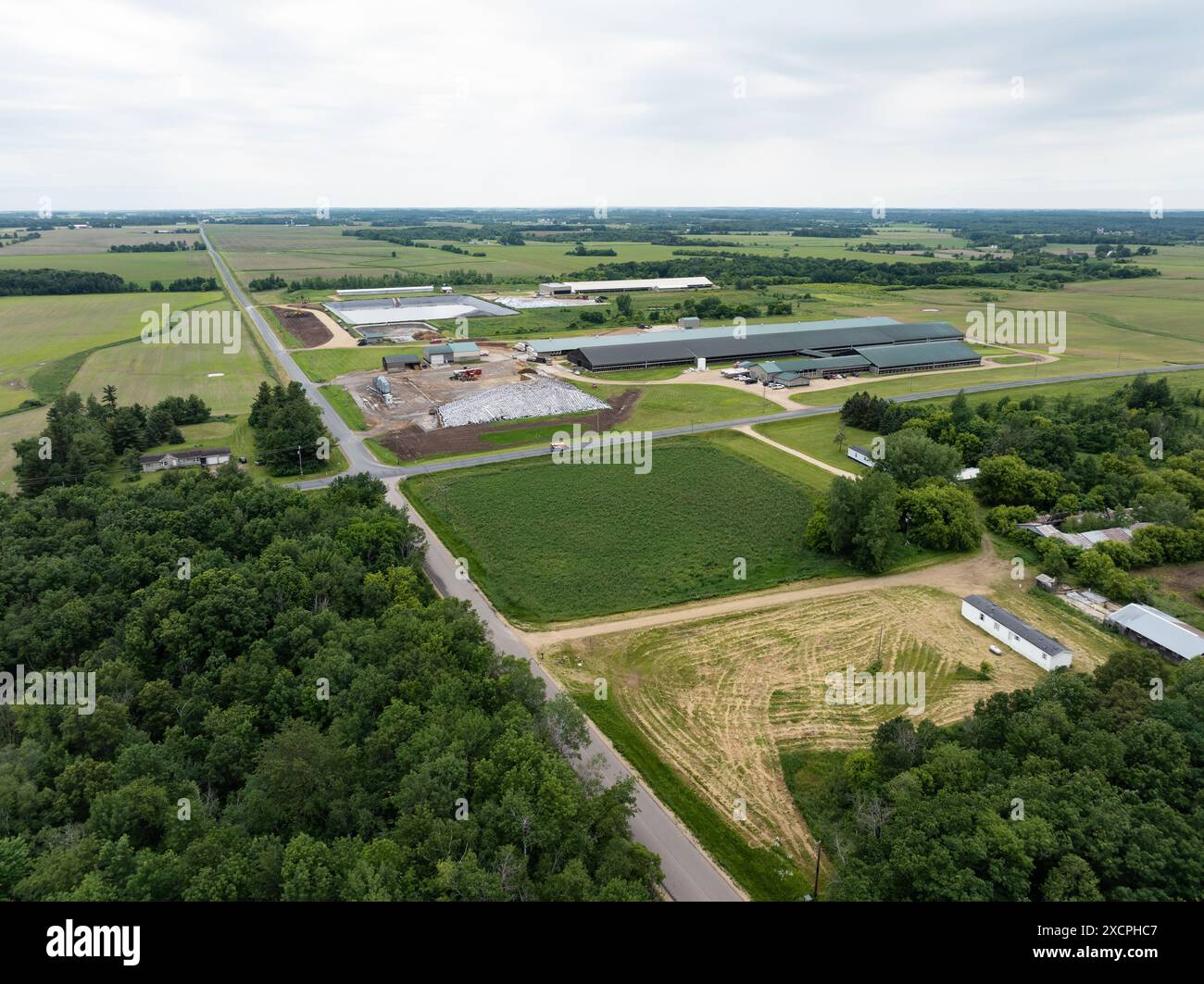 An aerial view of a large farm with multiple buildings and fields in a ...