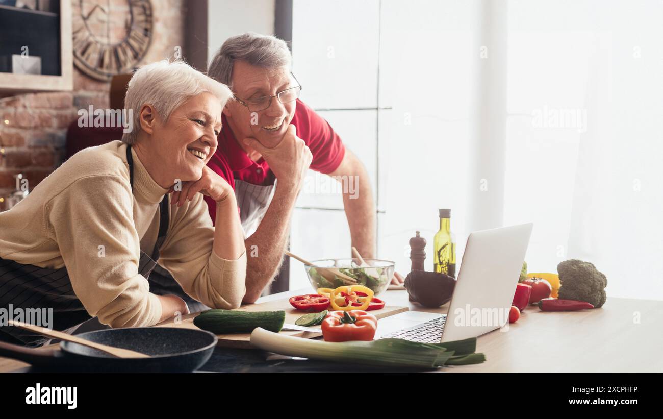 Senior Couple Ordering Groceries Online While Cooking in Kitchen Stock ...