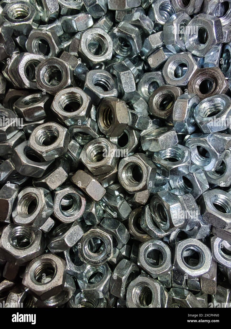 Lots of iron nuts, top view Stock Photo - Alamy