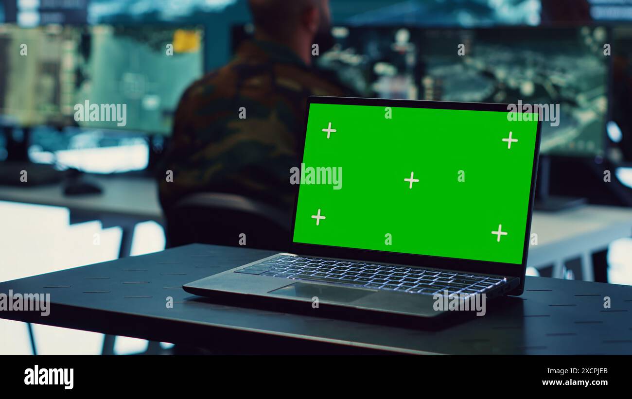 Laptop showing isolated mockup screen in army base of operations ...