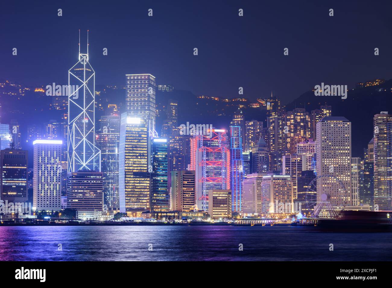 Awesome night view of Hong Kong Island skyline from Kowloon side. Skyscrapers in downtown ...