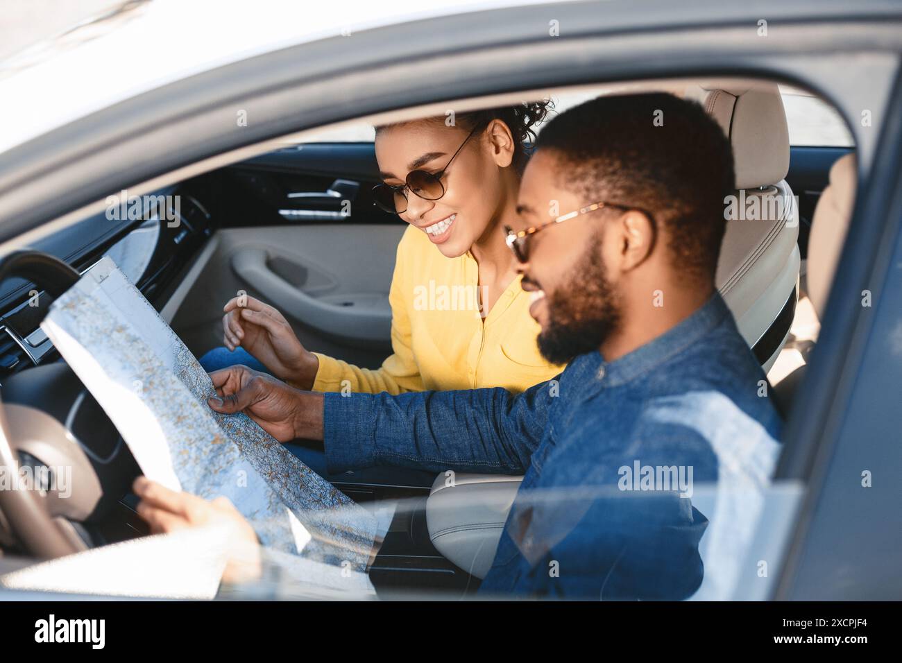 Couple Navigating With Paper Map in Car During Road Trip Stock Photo ...