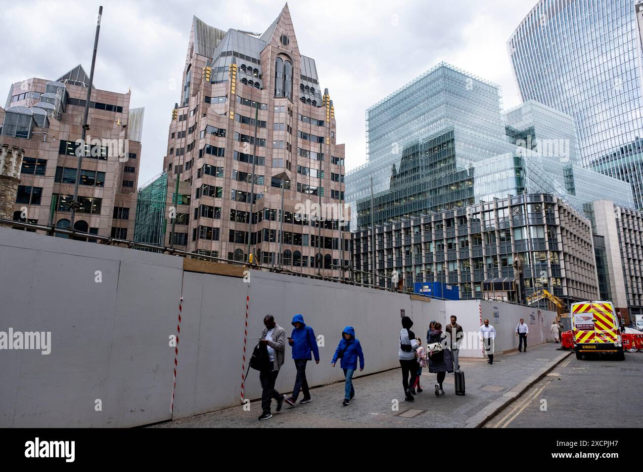 People pass hoardings surrounding a construction site at 50 Fenchurch ...