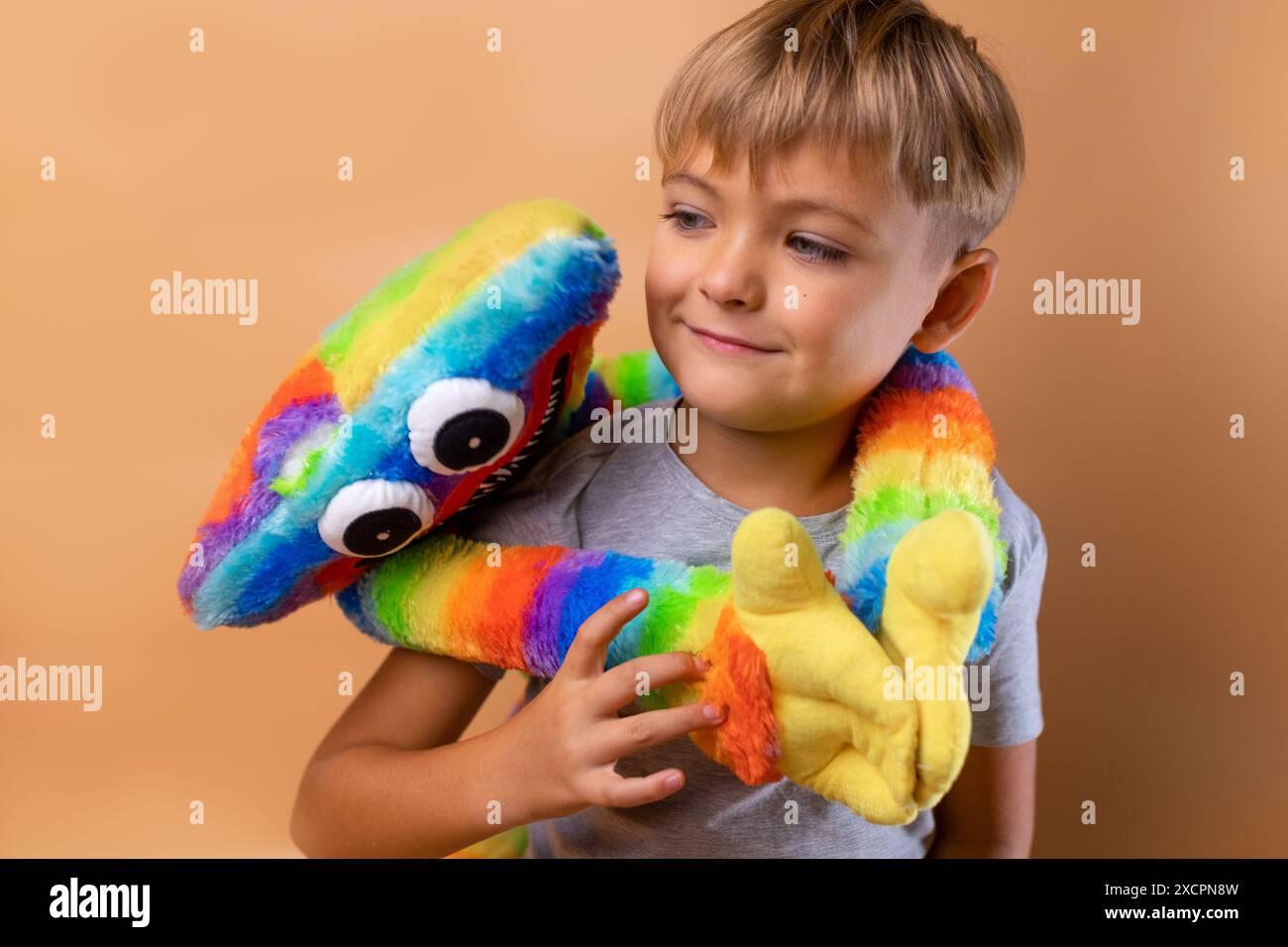 Positive little boy 6 years old with a bright colored toy. Concept ...