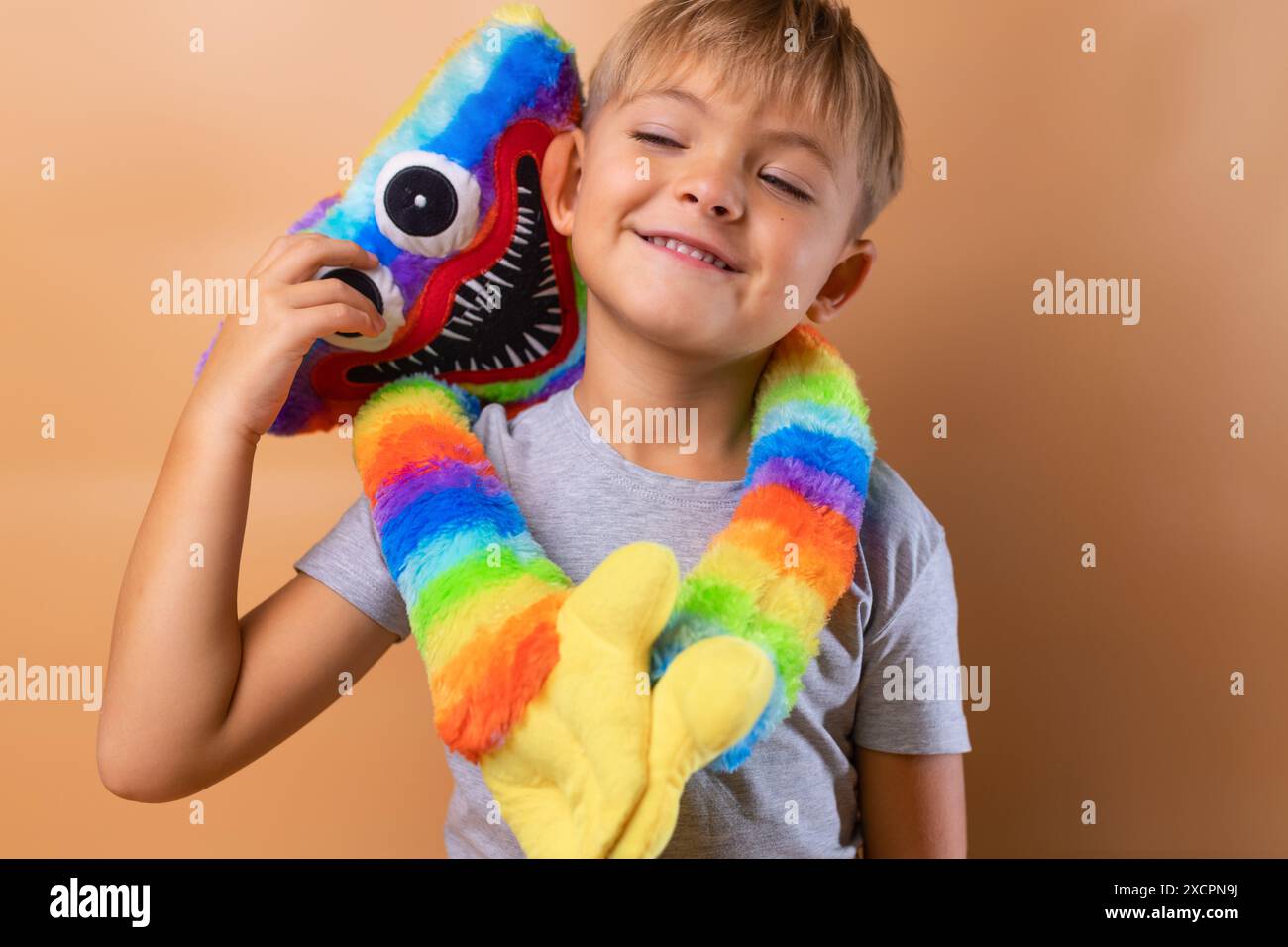 Positive little boy 6 years old with a bright colored toy. Concept ...