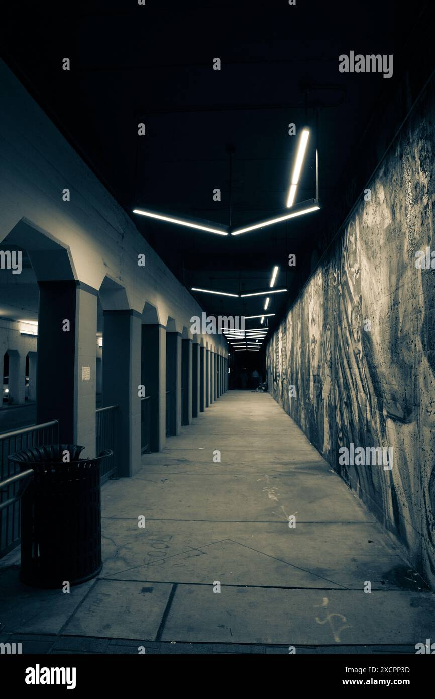 A dimly lit urban alleyway with modern overhead lighting Stock Photo ...