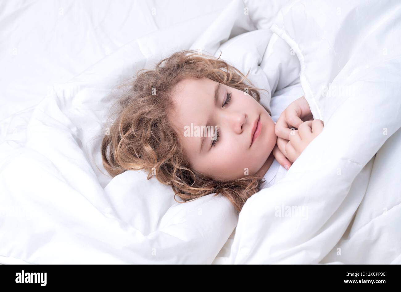 Bedding child. Little kid sleeps on bed, napping. Cute child sleeping ...
