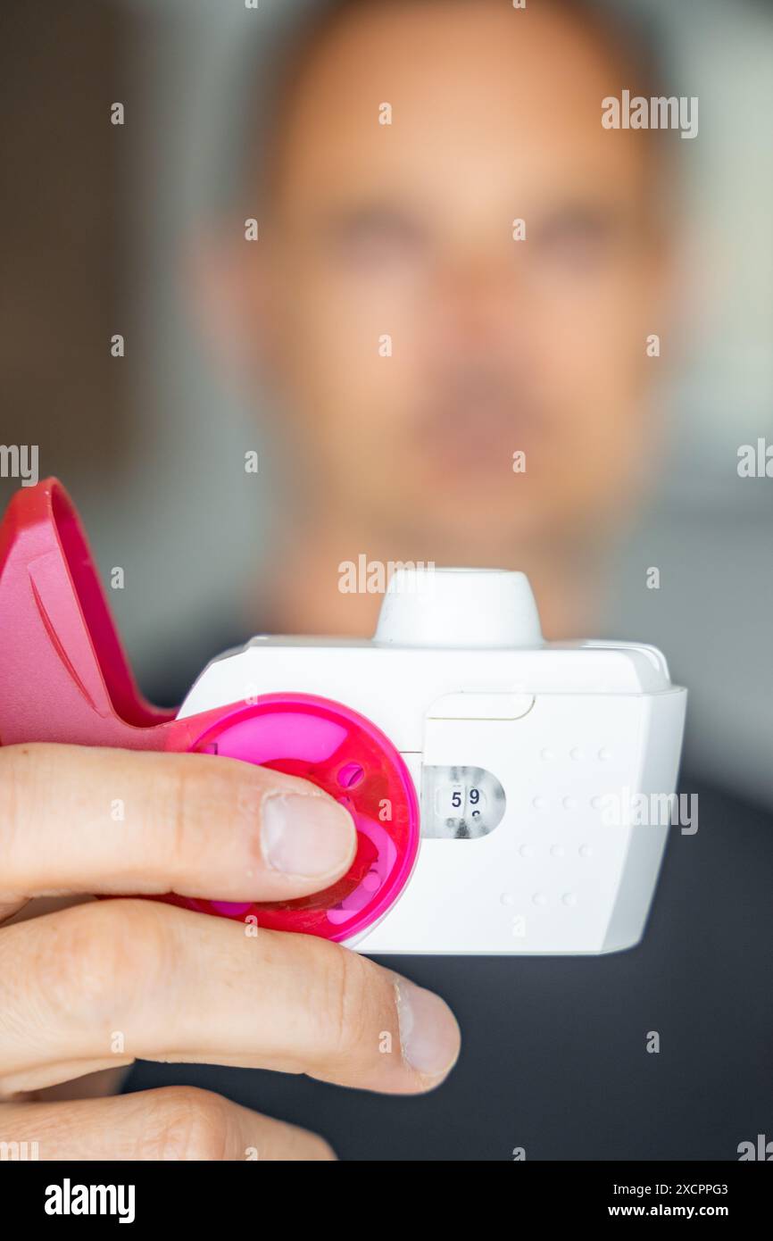 Close up view of man using medicine dry powder inhaler for treatment ...